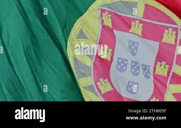 Close-up view of big national flag of Portugal waving in the wind from ...