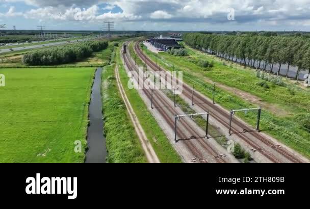 Dutch train in green open grassland landscape. Green alternative ...