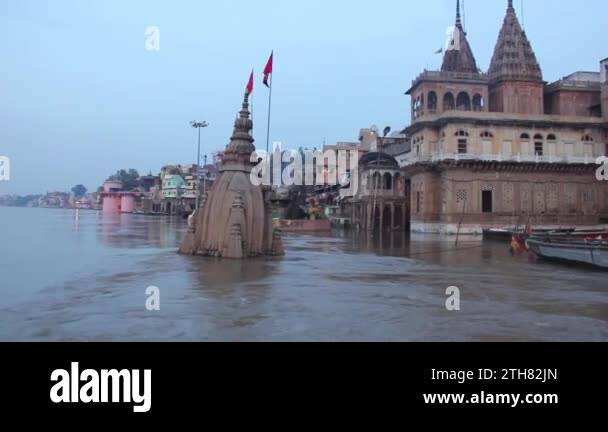 Sunrise on boat by Ganges River flooding temples and Ghats in the holy ...