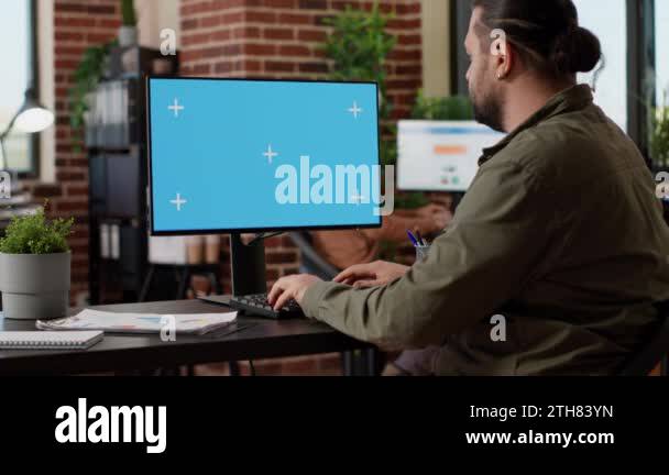 Company manager working with greenscreen mockup display on desktop ...