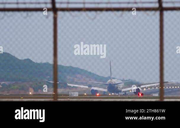 Braking wide-body airplane during landing, in motion. Reverse of ...