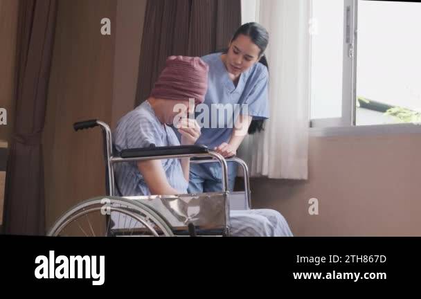Uniformed young Asian female therapy doctor with wheelchair male ...