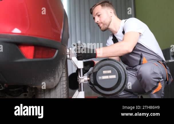 The auto mechanic diagnoses problems with car wheels and balances the ...