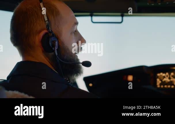 Male captain pilot flying airplane with dashboard command, using aerial ...