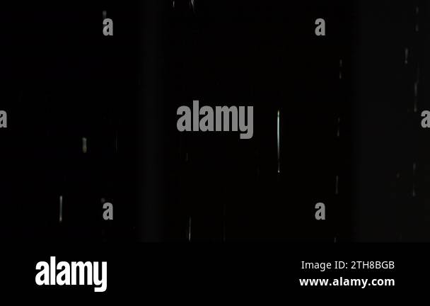 Drops of rain water dripping down in the night on dark background. Dark ...