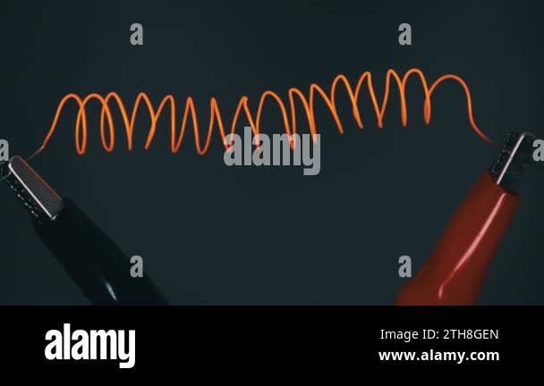 Nichrome filament glowing to red under high electric current. Nichrome ...