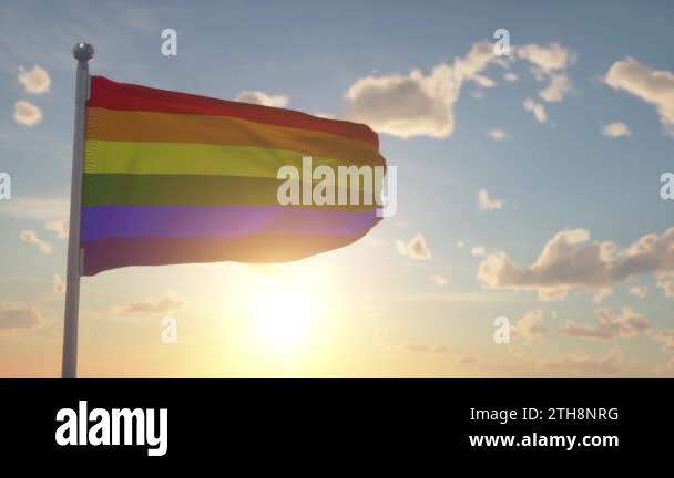 LGBT flag waving in the wind, sky and sun background. LGBT Rainbow Flag ...
