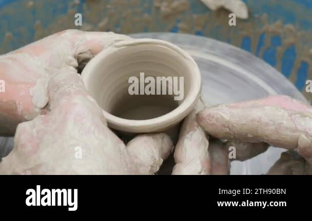 Clay modeling master class. Teacher show children hands clay pot ...