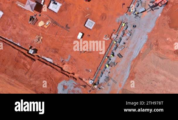 A mason is in the process of mounting a wall of aerated concrete blocks ...