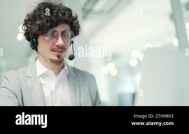 Portrait of young business man freelancer with wireless headset looking ...