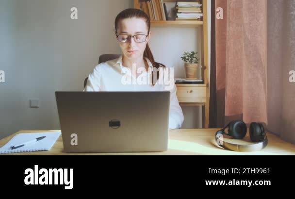 Young woman opens laptop starts working. Front view, portrait, desktop ...