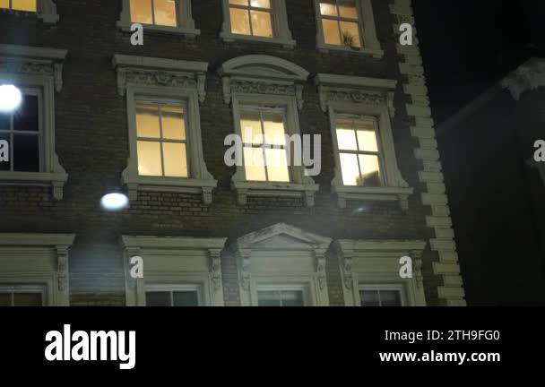 Traditional British building seen from inside a bus with light ...