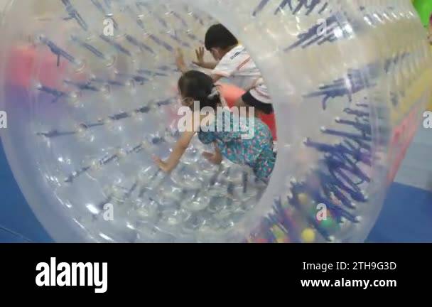 Happy Asian children having fun on entertainment center inflatable ...