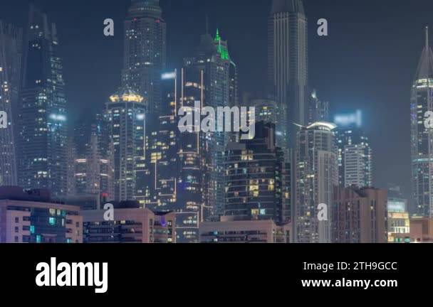 Dubai marina tallest block of skyscrapers with glowing windows night ...