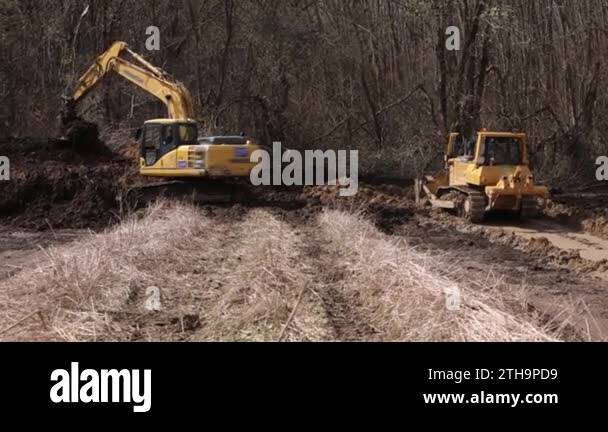 Bulldozer working on mud construction site. Excavator bucket teeth for ...