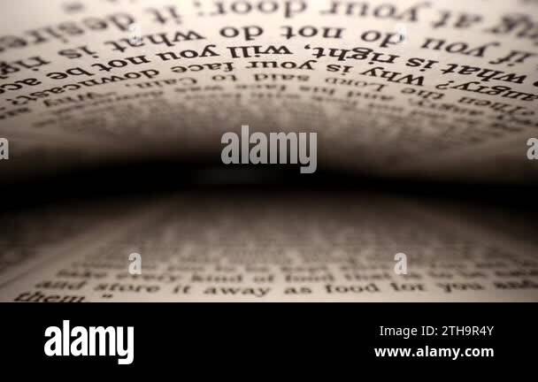 Slowly pushing lens into a book at a words eye view of the pages, pages ...