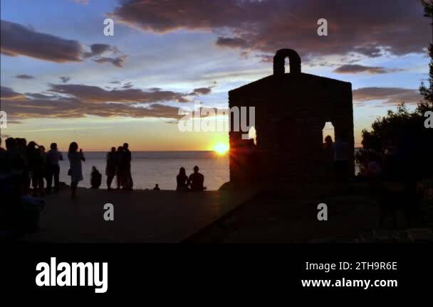 Romantic sunset timelapse 4K with black silhouettes of people and ...