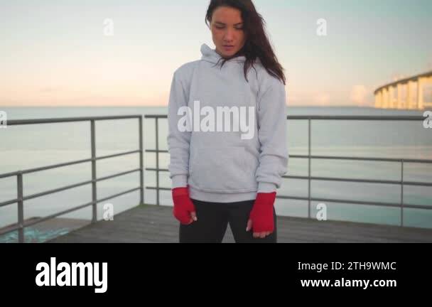 Female boxer in fighting stance staring into the frame, looking in ...