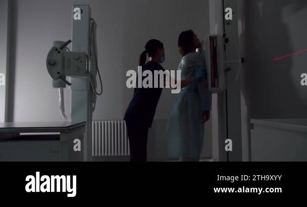 Machine while Female Doctor Adjusts it. Healthy Patient Undergoes ...