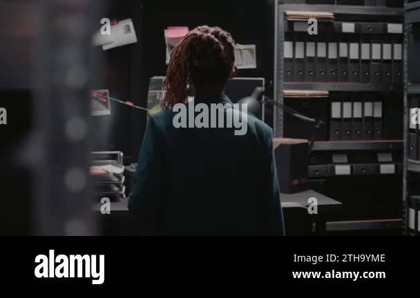 Law enforcement agent checking detective evidence map to find criminal ...