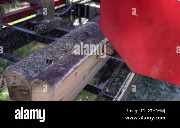 Closeup footage of a trailer sawmill with ribbon saw blade producing ...