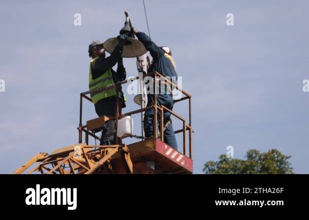 metal pole, Street light, light bulb. Employee repair workshop works on ...