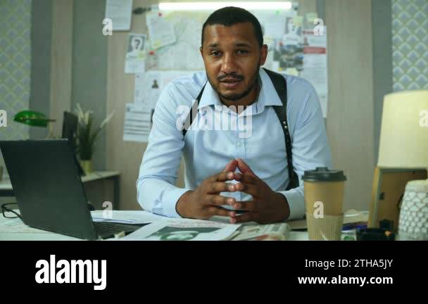 African american detective talking to the camera at police department ...