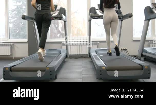 Rare view of a blonde woman in headphones and a girl with long dark ...