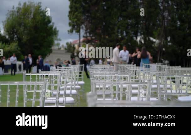 Guests arriving to wedding event and making photos of outdoor venue ...