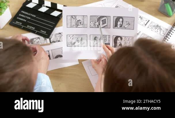 The director and cameraman examine the frames of the storyboard on ...