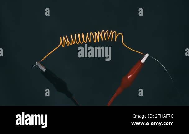 Nichrome filament glowing to red under high electric current. Nichrome ...