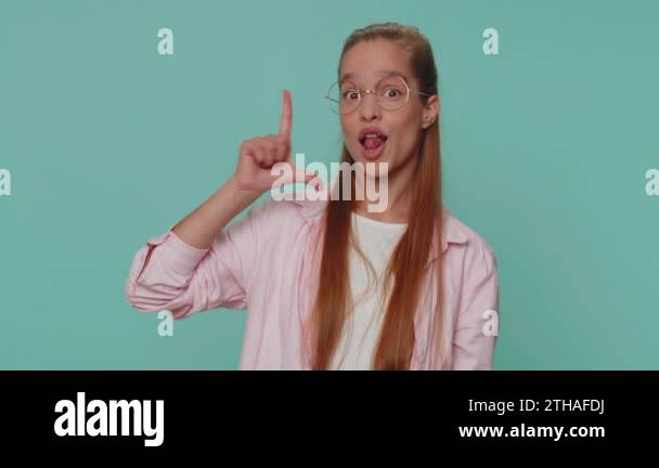 Teenager young girl showing loser gesture and pointing on you, blaming ...