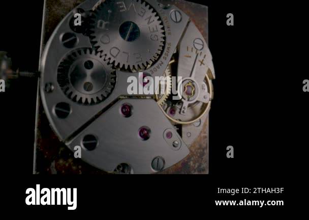 Disassembled vintage pocket watch with clockwork turning on black ...