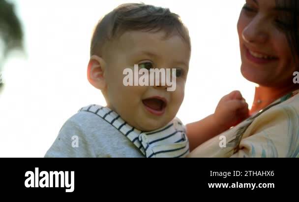 Baby with mother in outdoors with sunlight lens-flare sunshine Stock ...
