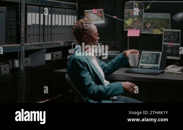 African American Woman Working In Police Archive Space Preparing To