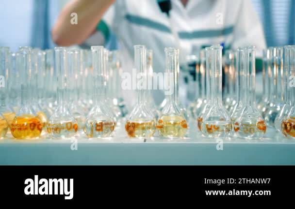 The researcher adds the solution to the test tubes for further study ...