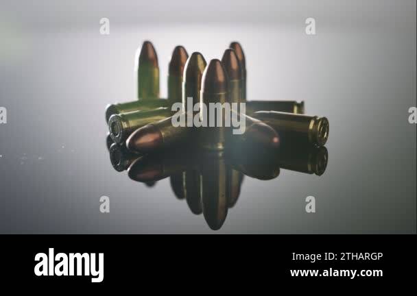 9mm gun rotating on a reflective surface Stock Video Footage - Alamy