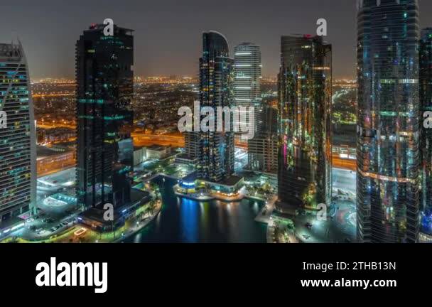 Tall residential buildings at JLT district aerial during all night ...