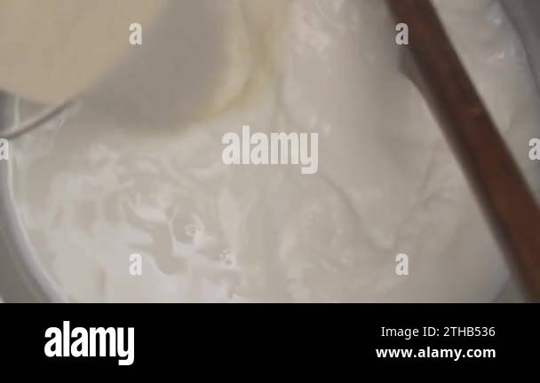 Close-up of cooking bechamel sauce. Professional chef pouring milk into ...