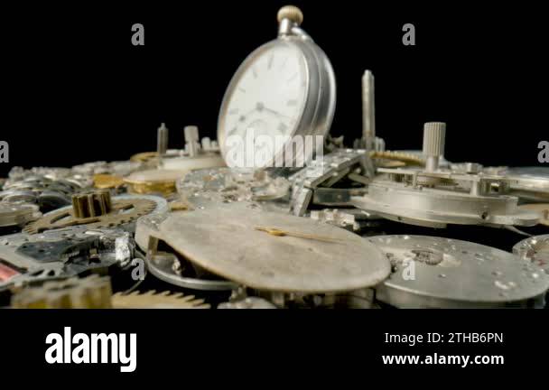 Gray vintage pocket watch dial on a pile of clockwork parts. Round old ...