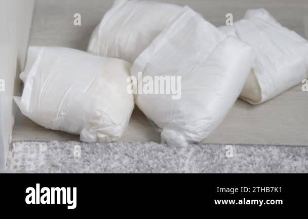 many dirty full baby diapers on floor bed or in blue trash plastic bag ...