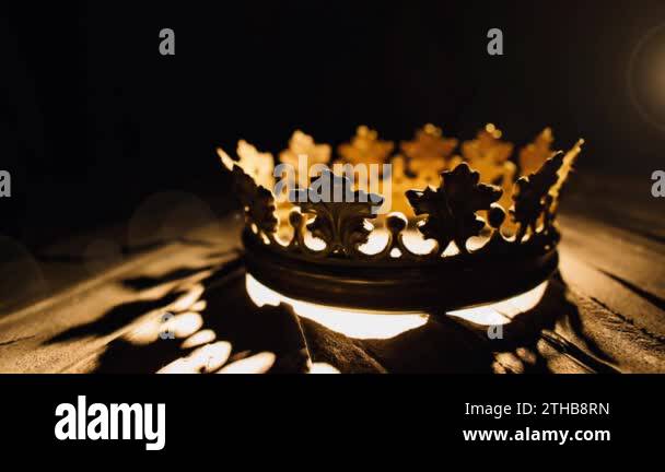 The crown on a black background is highlighted by a golden ray. Game of ...