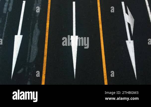 Overhead shot of lanes and arrows pointing down with trucks, buses and ...