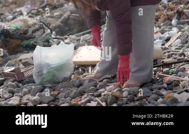 plastic polluted public beach. The problem of garbage recycling. woman ...
