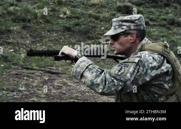 Soldier shooting a sub machine gun, first single shot then full auto ...