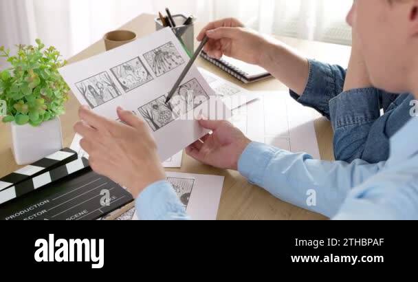 The director and cameraman examine the frames of the storyboard on ...