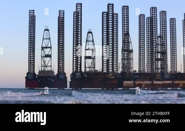 beach waves with oil platform in ocean. Caspian sea offshore oil rig ...