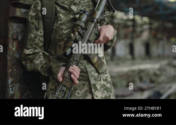 Professional fully equipped female soldier taking cover behind concrete ...