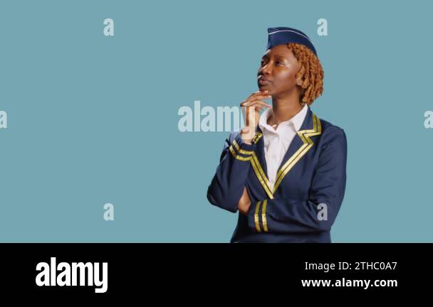 Young air hostess turning on lightbulb with new idea, feeling pensive ...