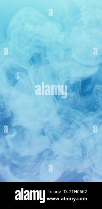 Vertical video. Color smoke. Mist cloud. Ink water splash. Light blue ...